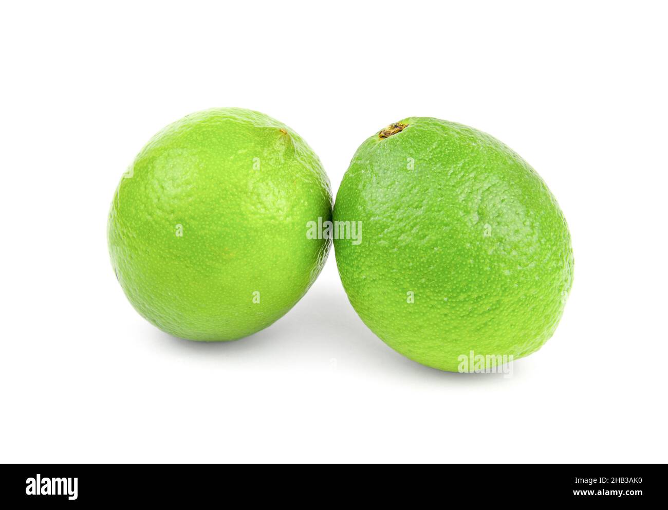 Two juicy lime isolated on white background cutout Stock Photo - Alamy
