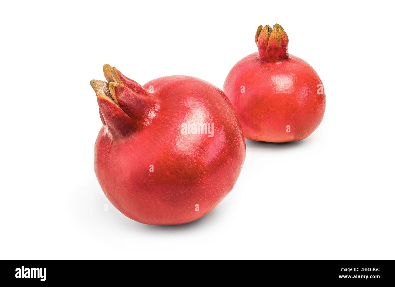 Two whole pomegranates isolated on white background cutout Stock Photo ...