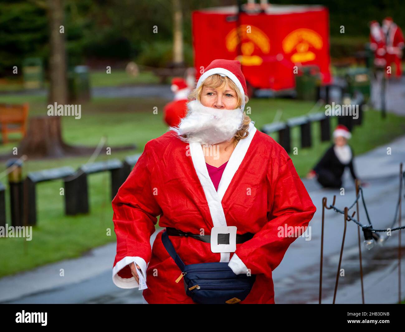 Close up of woman running in a Santa Dash Stock Photo - Alamy