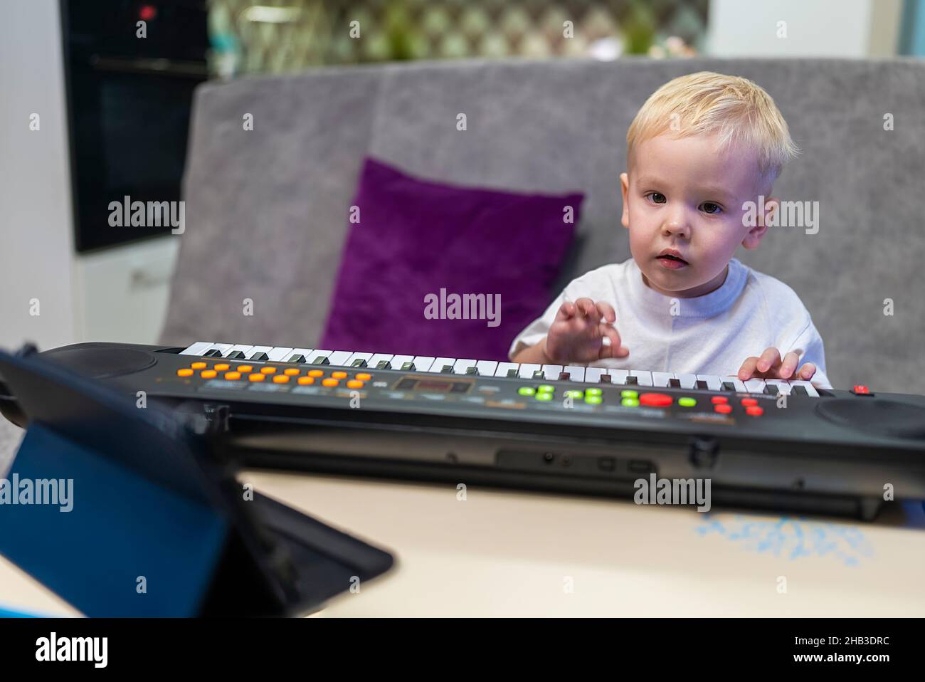 little boy learning to play the piano at home Stock Photo - Alamy