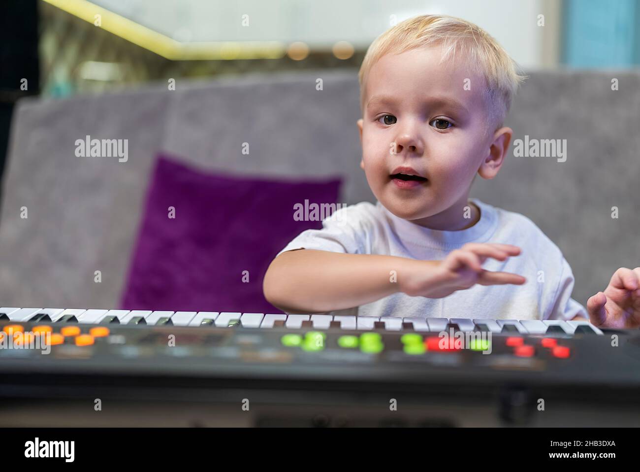 little boy learning to play the piano at home Stock Photo - Alamy