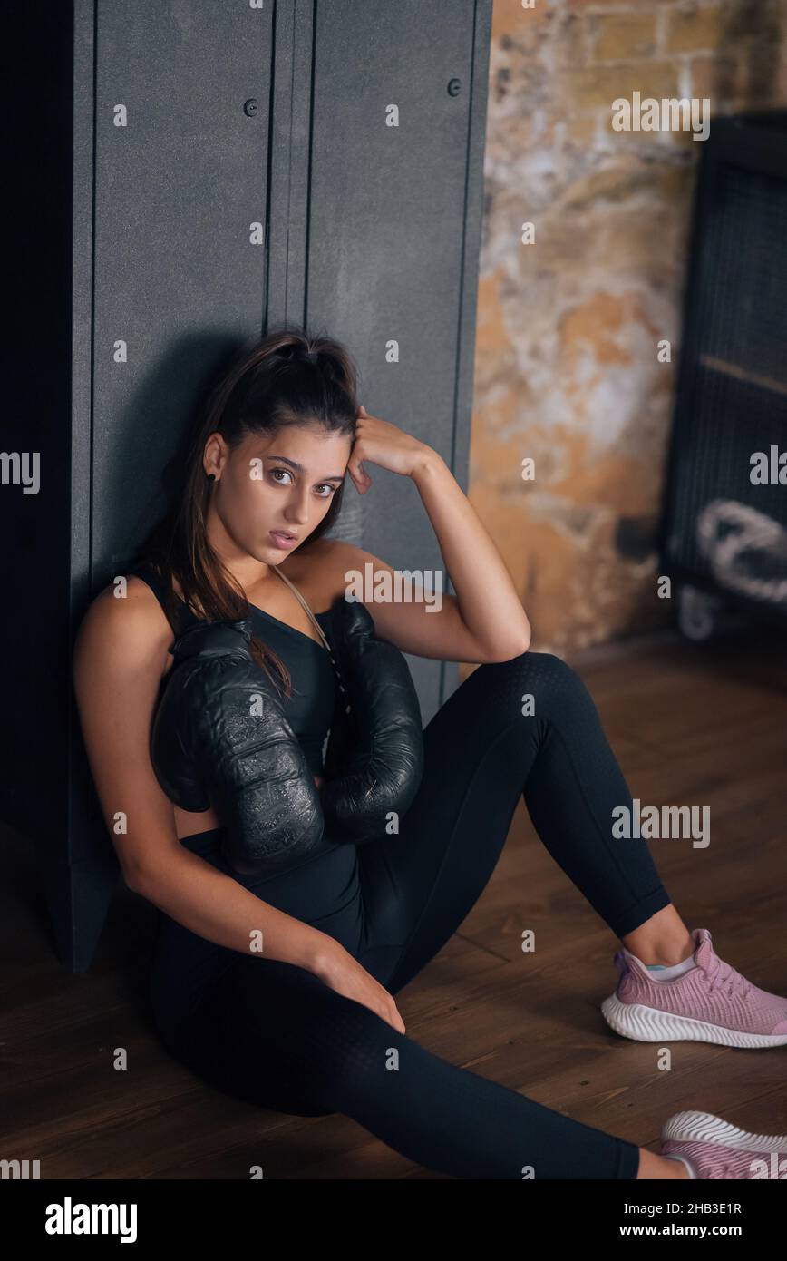 Sporty woman in sportswear posing on camera with boxing gloves Stock ...