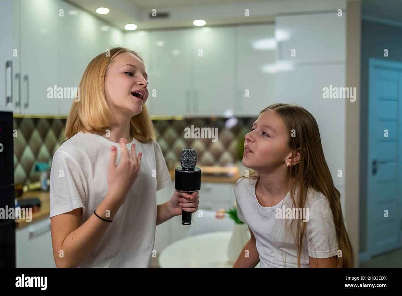 Two girls playing guitar singing hi-res stock photography and images ...