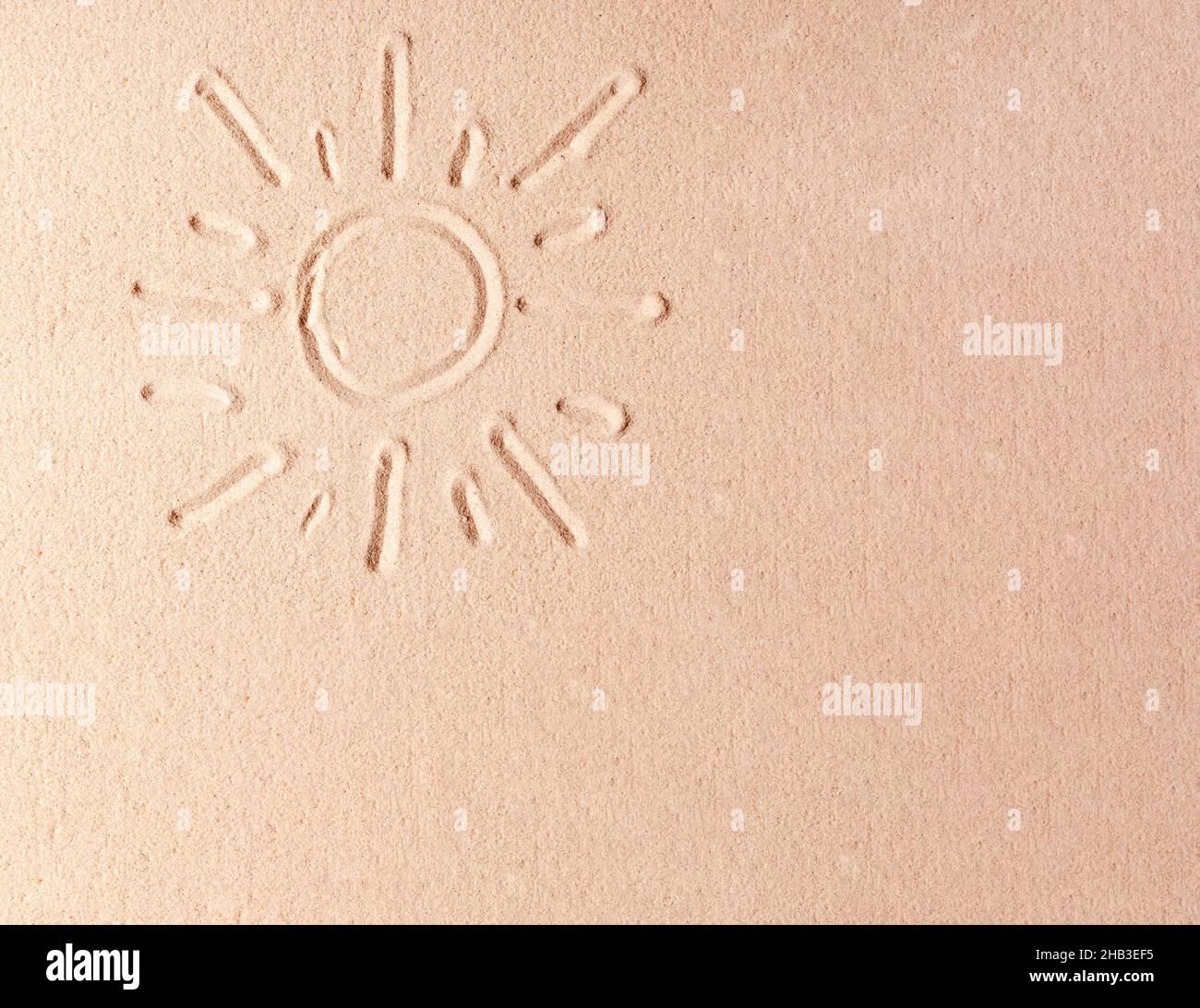 Drawn sun on the sand, concept, use as background Stock Photo - Alamy