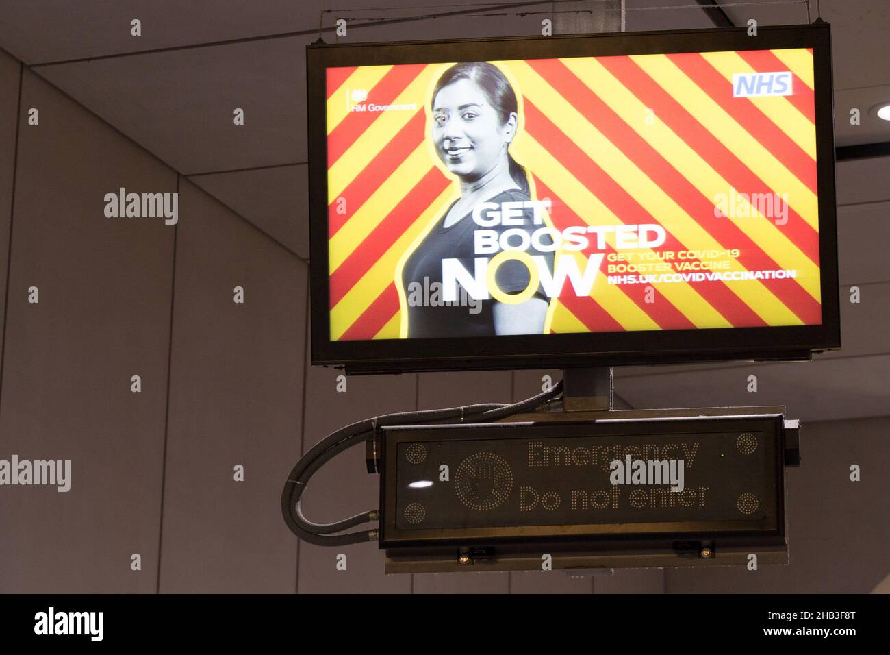 London UK 16 December 2021. Digital poster "GET BOOSTED NOW" as ...