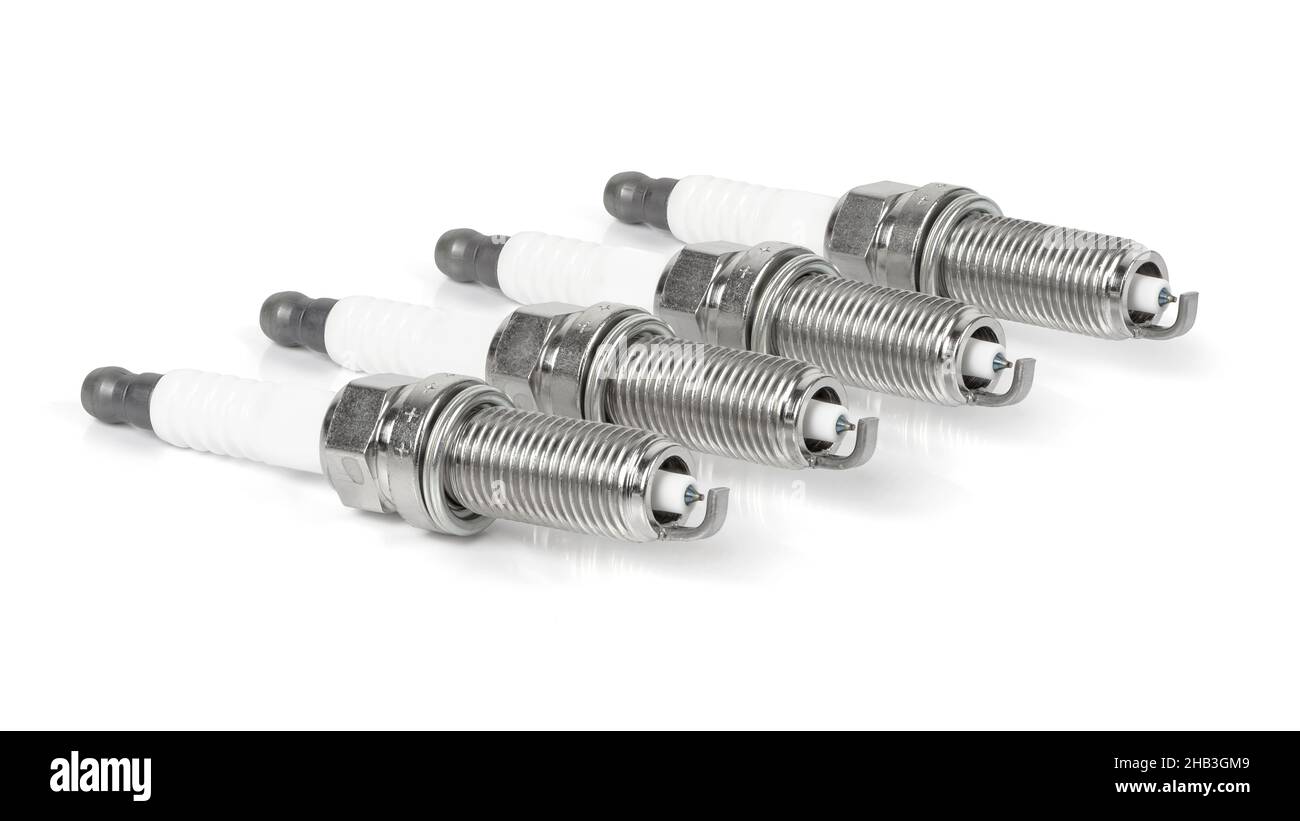 Four iridium spark plugs in a row isolated on white background with ...