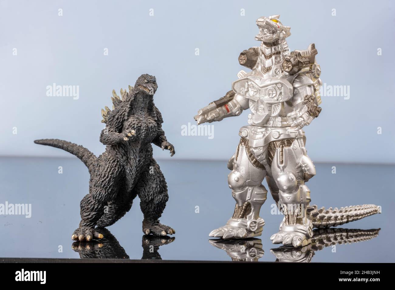 Two giant lizard figure toy monsters facing each other. Legendary Asian ...