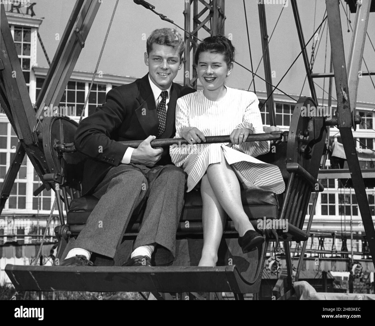 Couple sitting on a car on a ferris wheel in an amusement park on Coney ...
