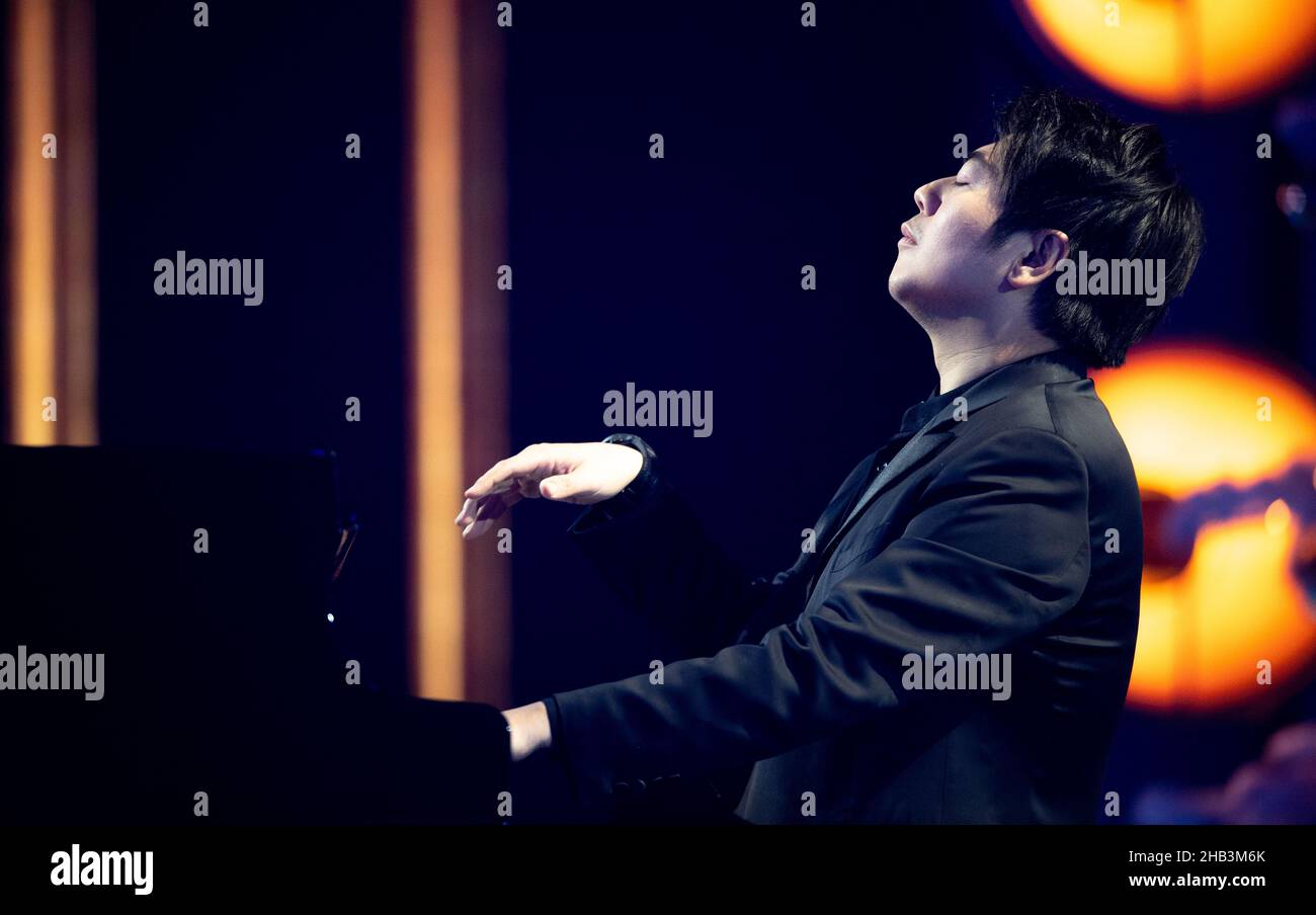 Leipzig, Germany. 16th Dec, 2021. Chinese pianist Lang Lang sits on ...