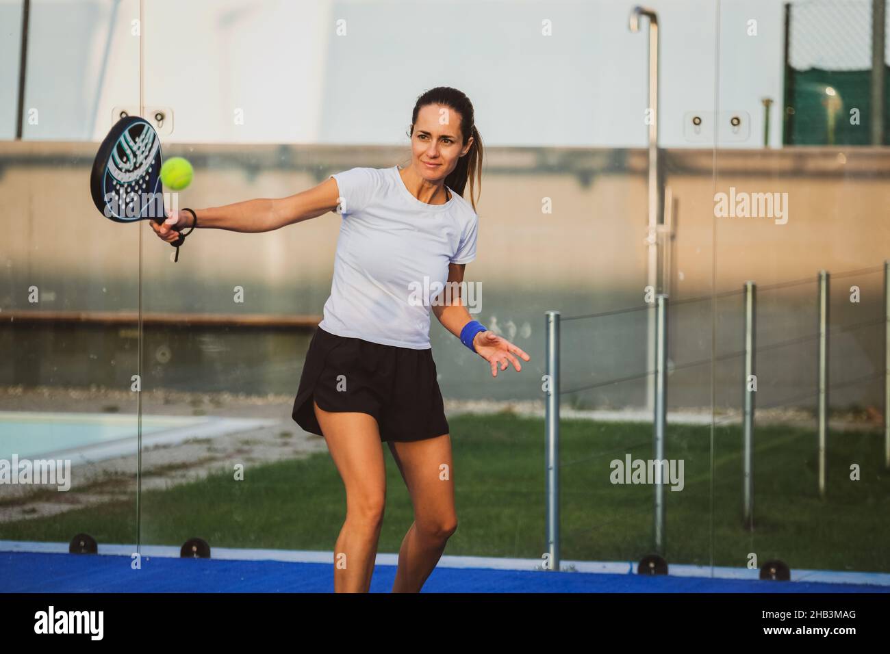 Padel match in a blue grass padel court - Padel player playing a match ...
