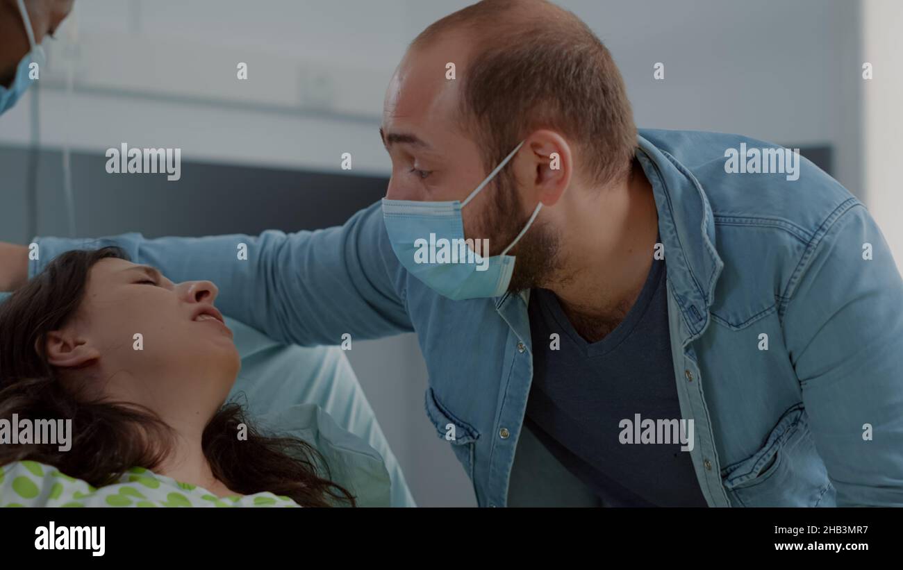 African american nurse helping with childbirth in hospital ward ...