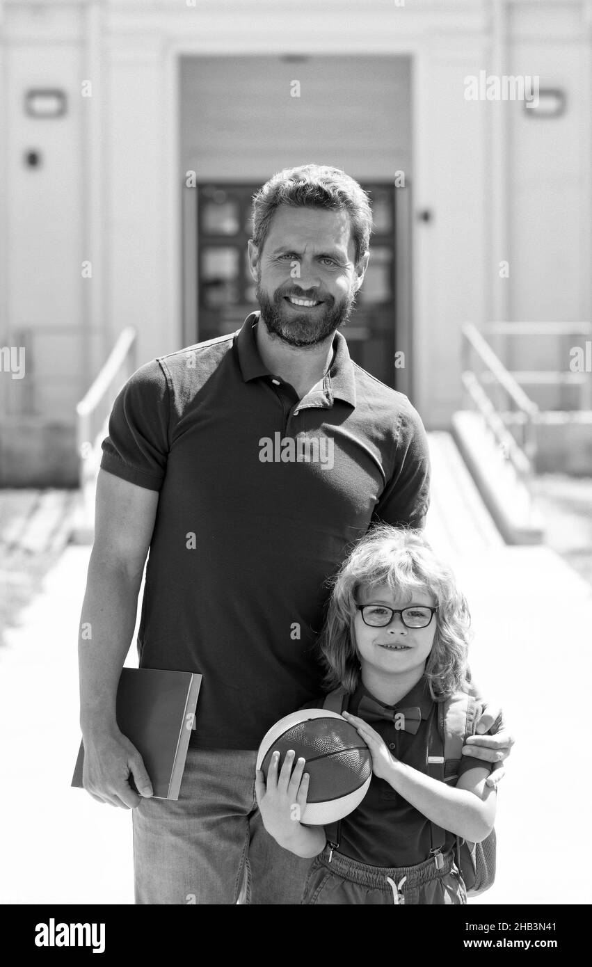 happy father with nerd son in glasses coming back from first day at ...