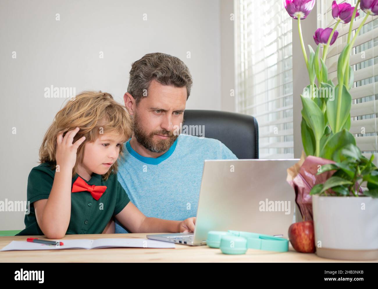homeschooling and elearning. back to school. father and child use ...