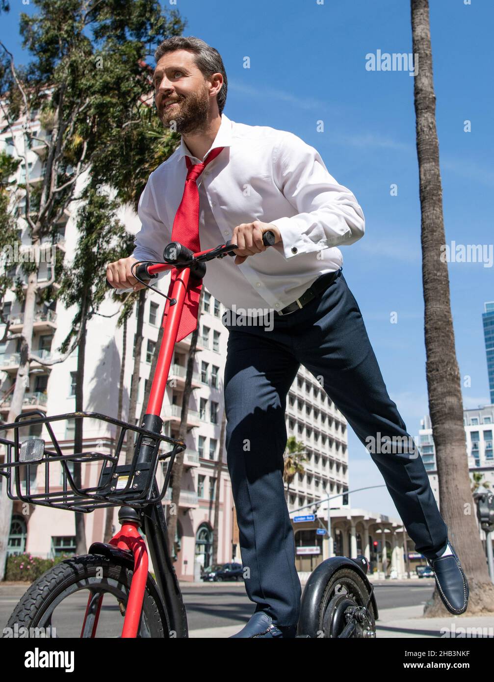 Scooting around the city. Happy boss enjoy scooting. Riding stand-up ...