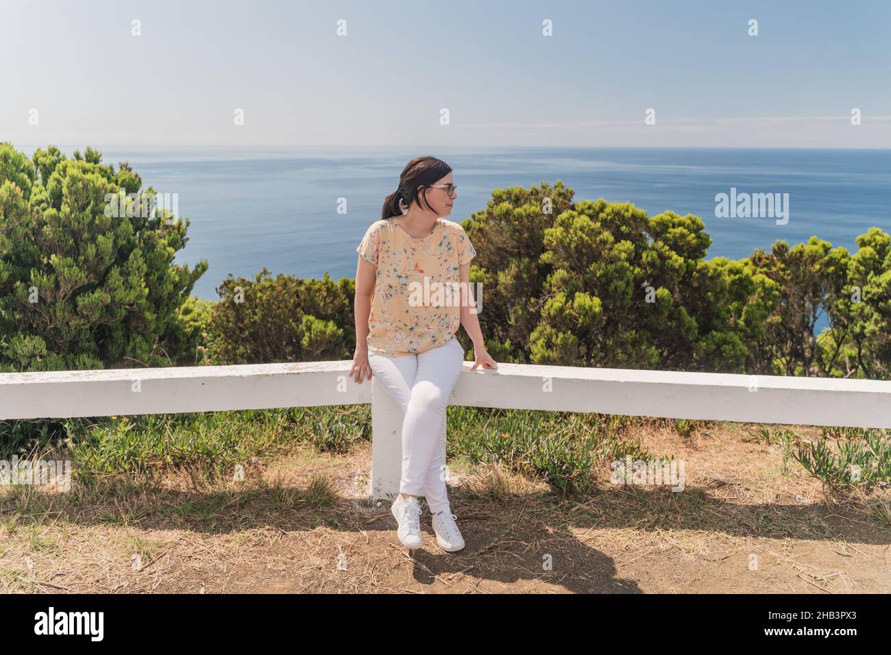 Female admiring the beautiful view of the Monte Brasil, Terceira Island ...