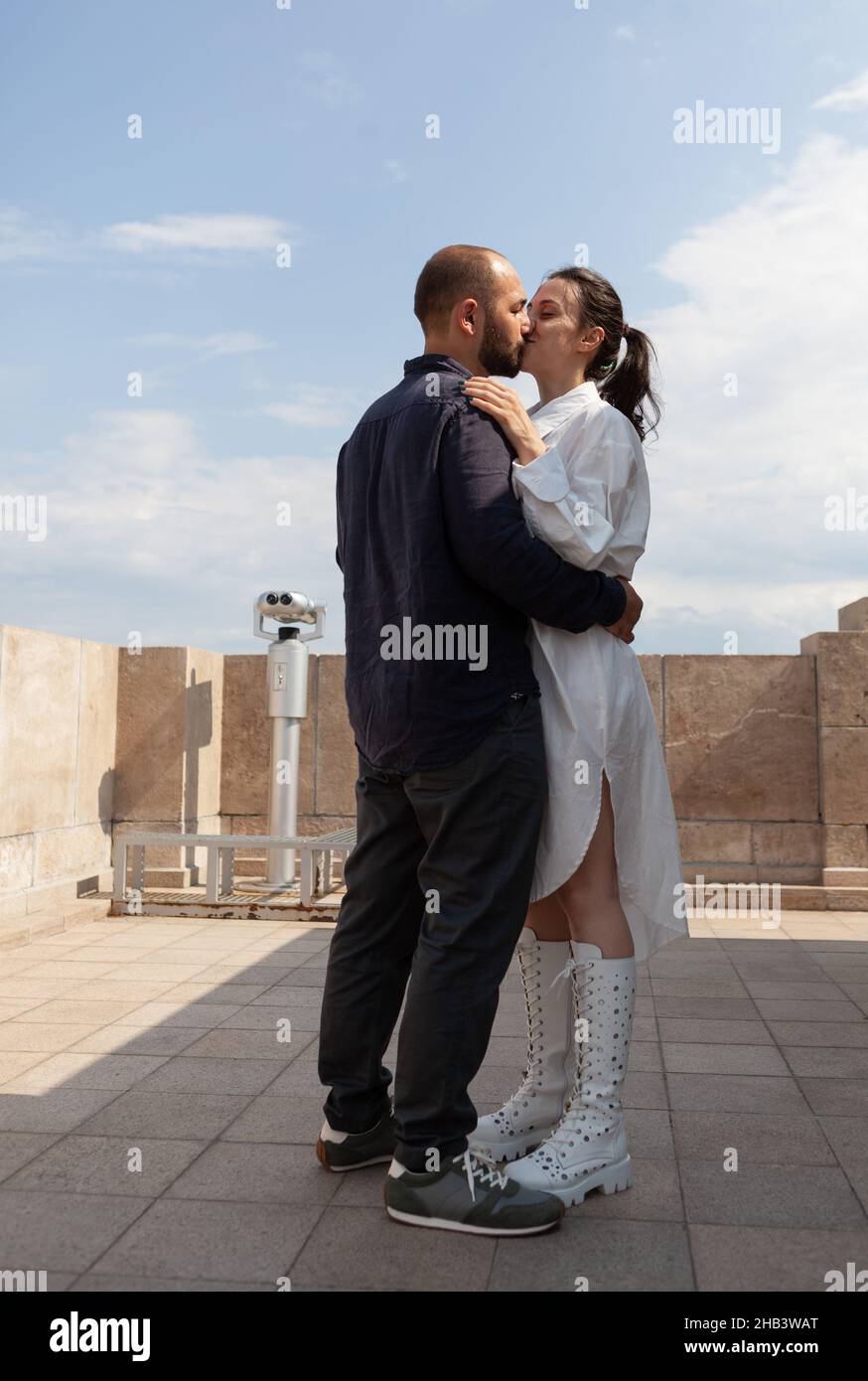 Romantic couple kissing on tower terrace celebrating relationship ...