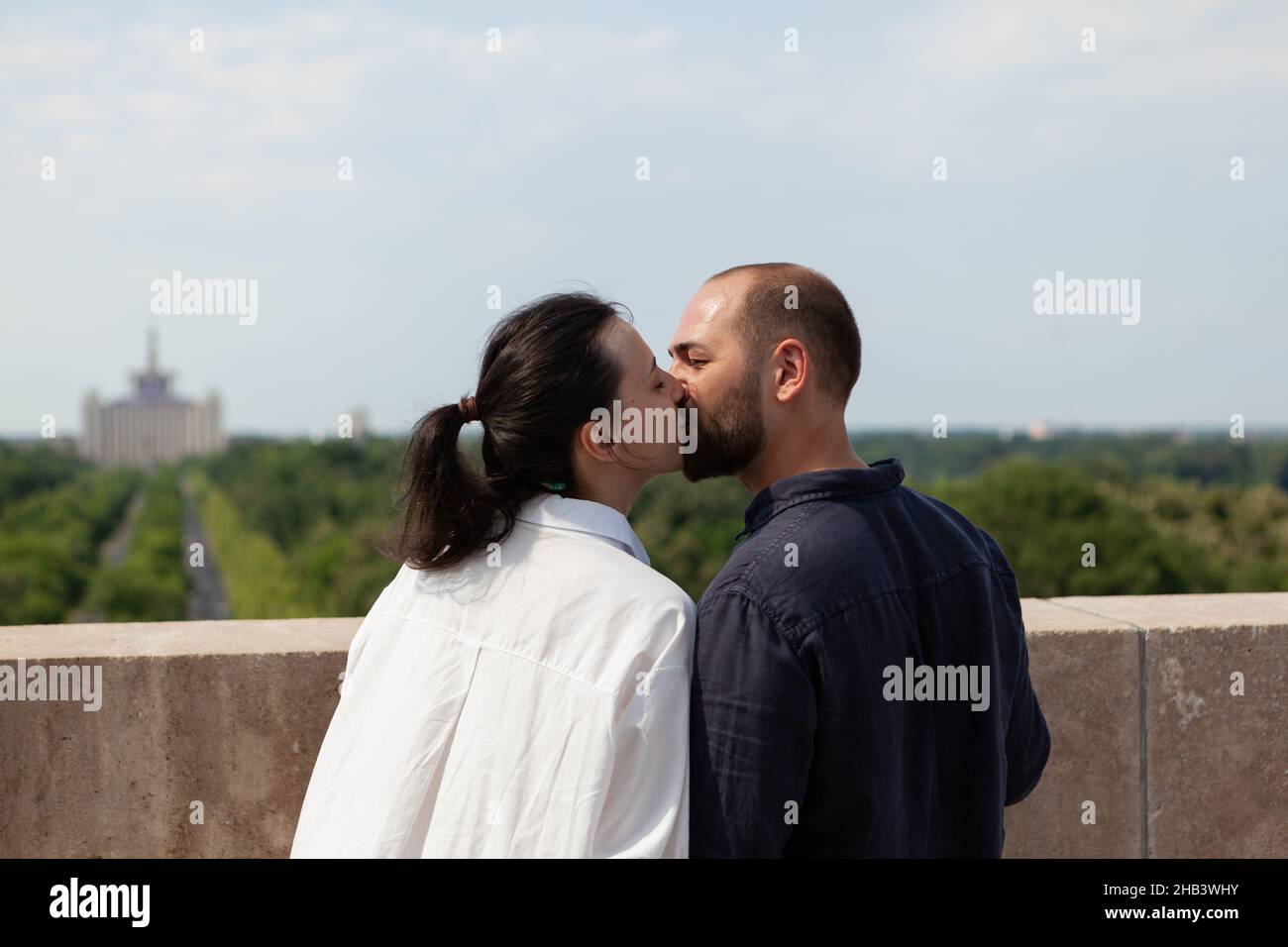 Married romantic couple kissing on building tower celebrating ...