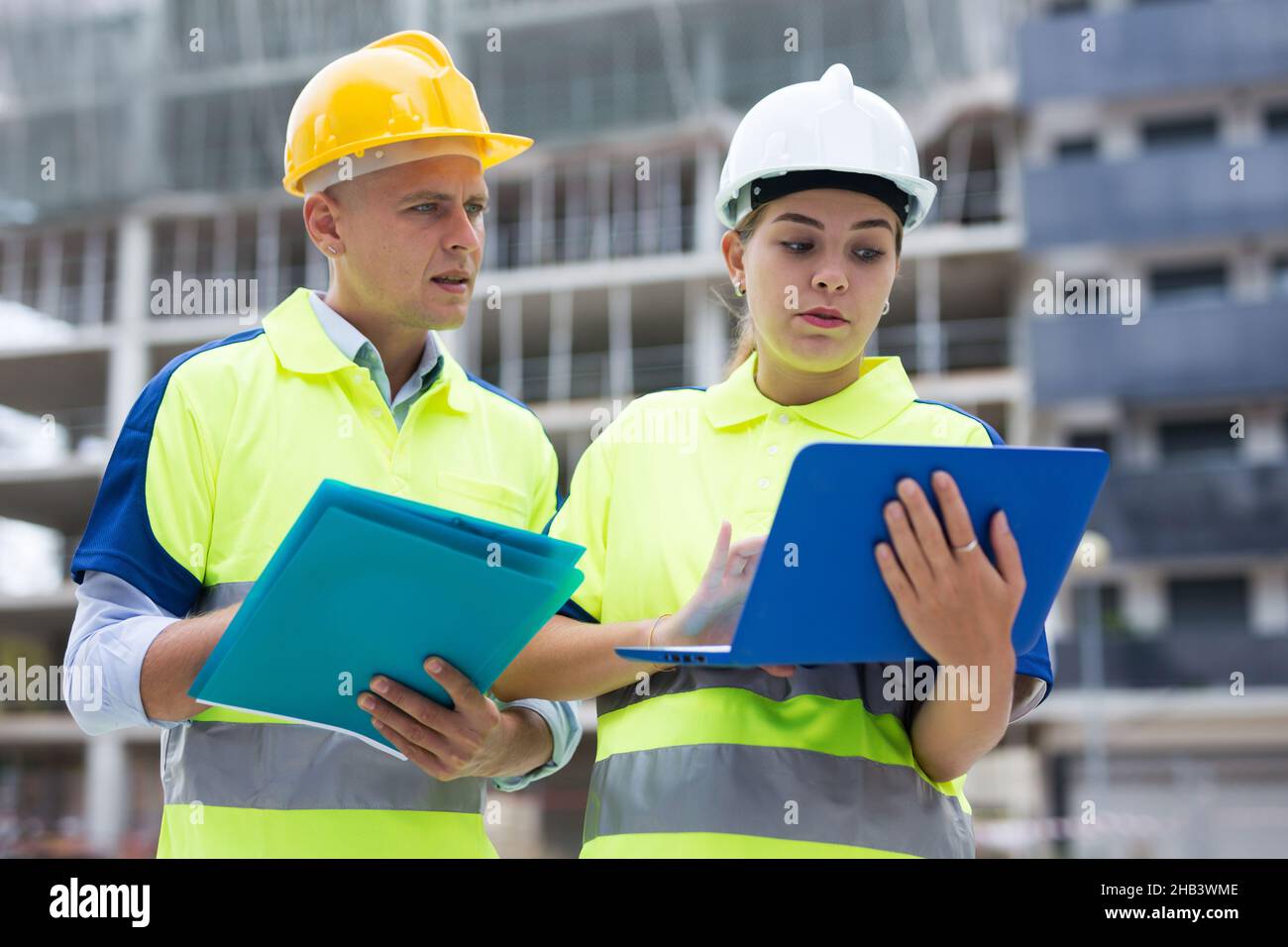 Male and female engineers in construction area Stock Photo - Alamy