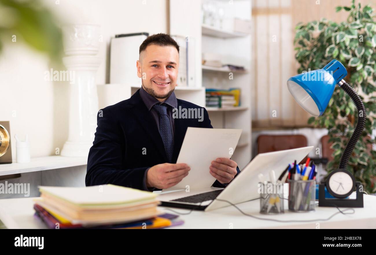 Professional business man using laptop at workplace in modern office ...