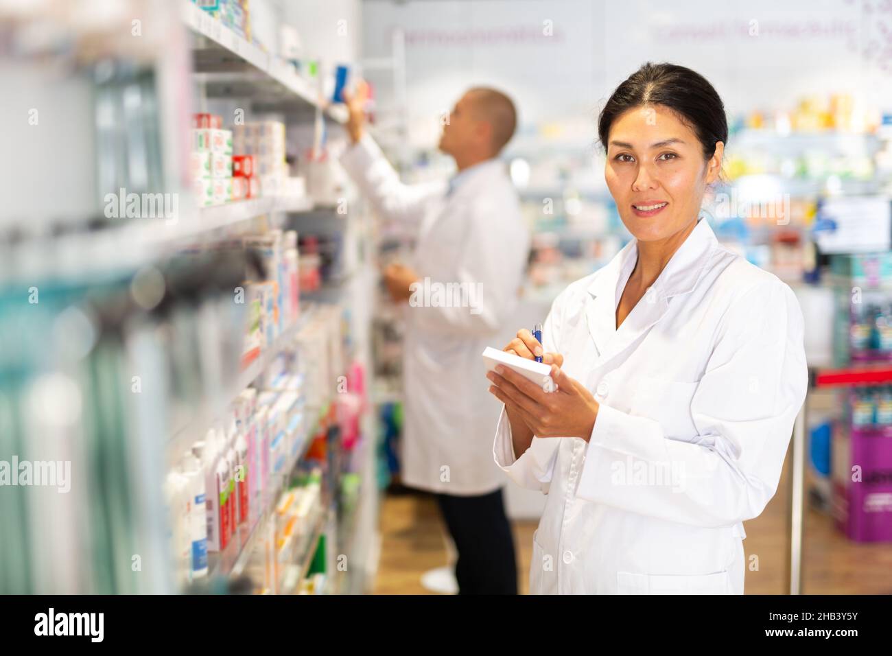 Woman doctor standing in chemist shop Stock Photo - Alamy
