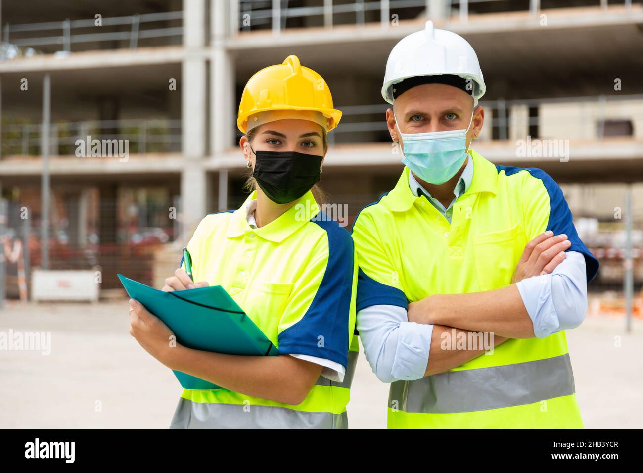 Civil engineers in masks checking work process Stock Photo - Alamy