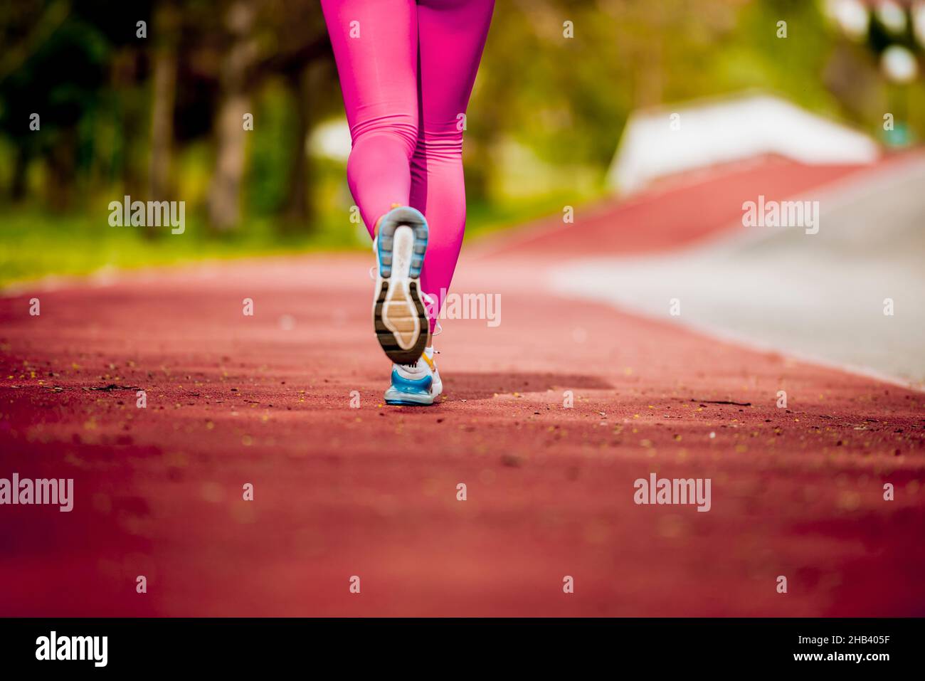Woman with athletic legs on jog or run on trail in forest in healthy ...