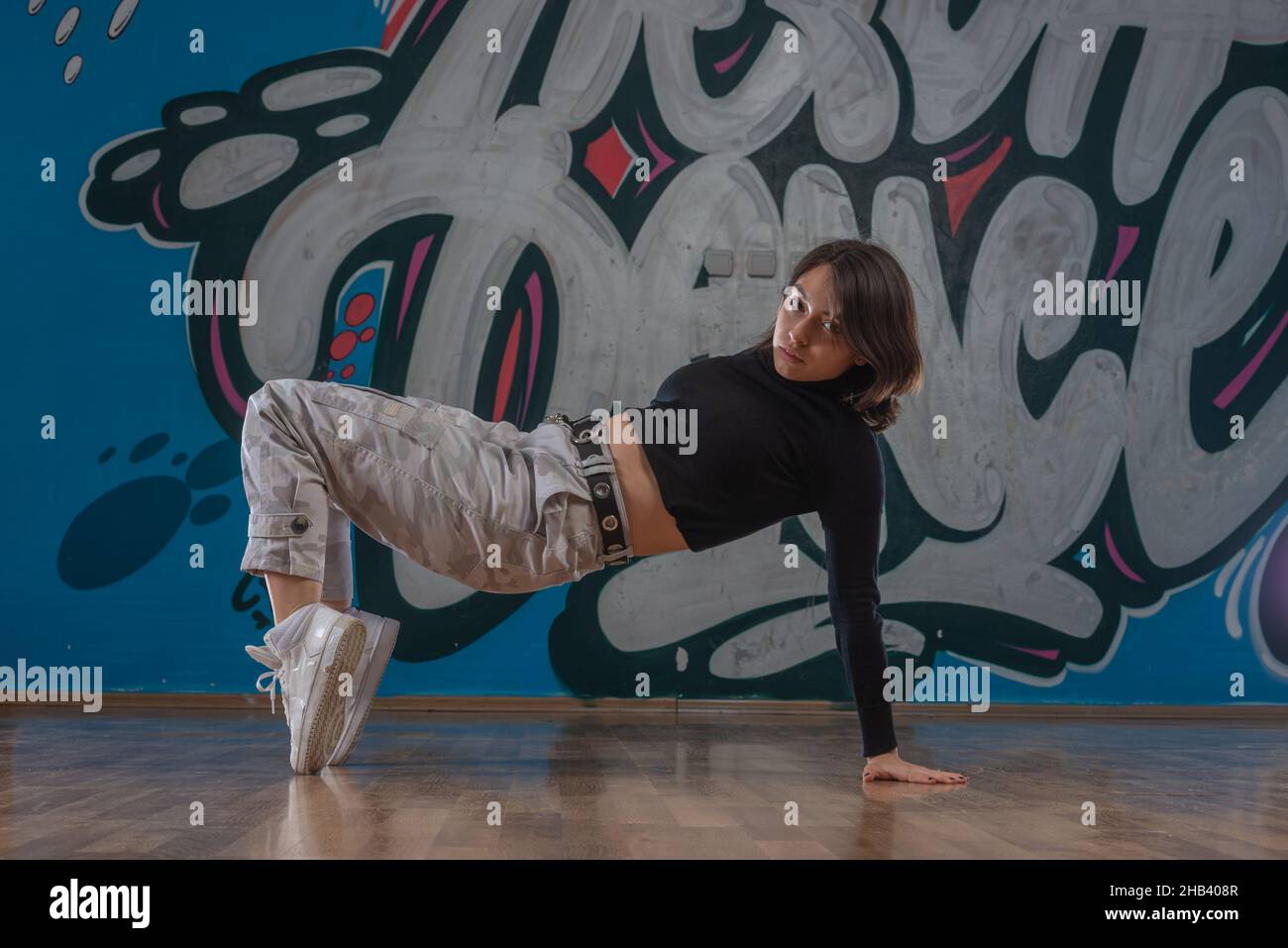Modern style dancer jumping on studio background Stock Photo - Alamy