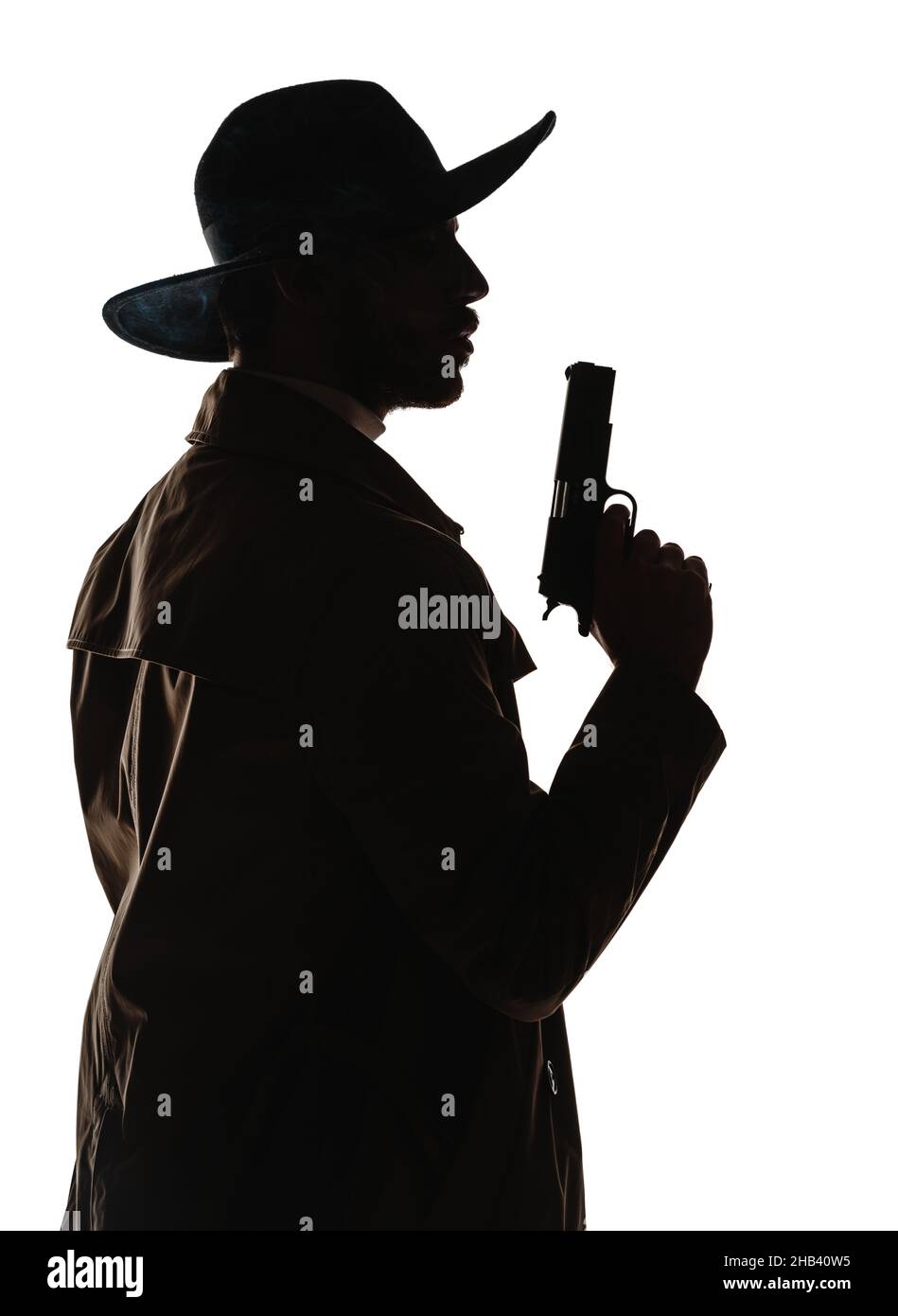 Body shot of an attractive male model posing with a gun in modern ...