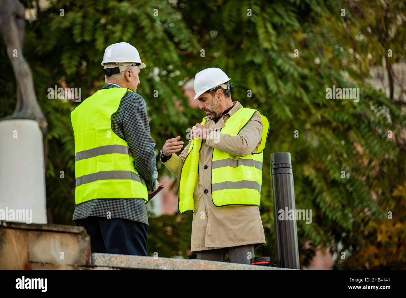 Two construction workers are getting ready to see the building Stock ...