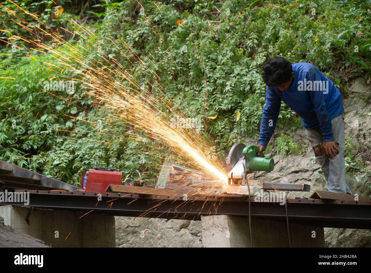 A professional craftsman is cutting metal with a rotatable diamond ...