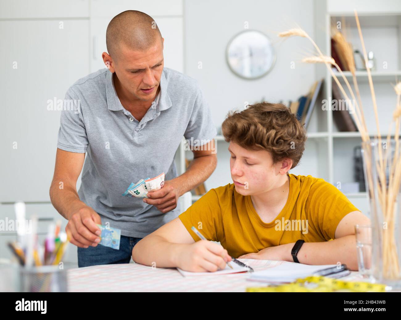 Father and son counting money hi-res stock photography and images - Alamy