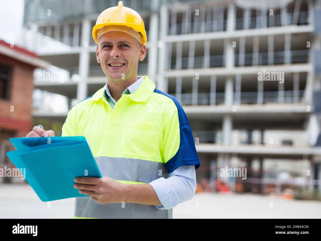 Male engineer checking work process in construction site Stock Photo ...