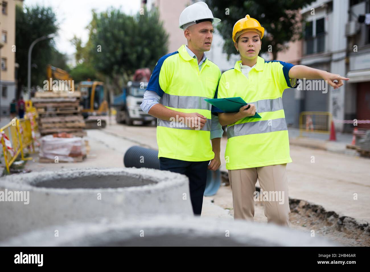 Civil engineers checking work process in construction site Stock Photo ...