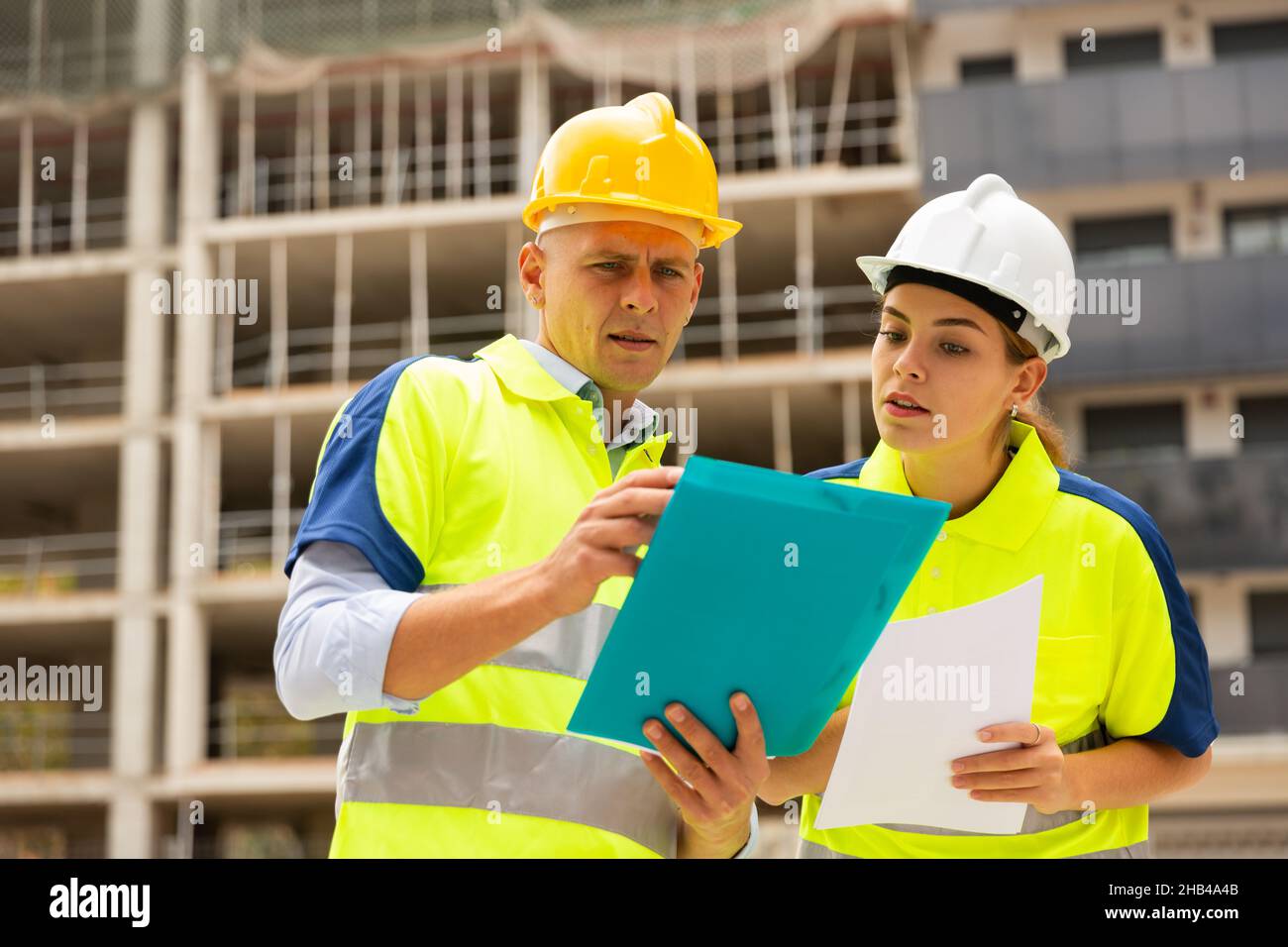 Man and woman engineers in construction site Stock Photo - Alamy