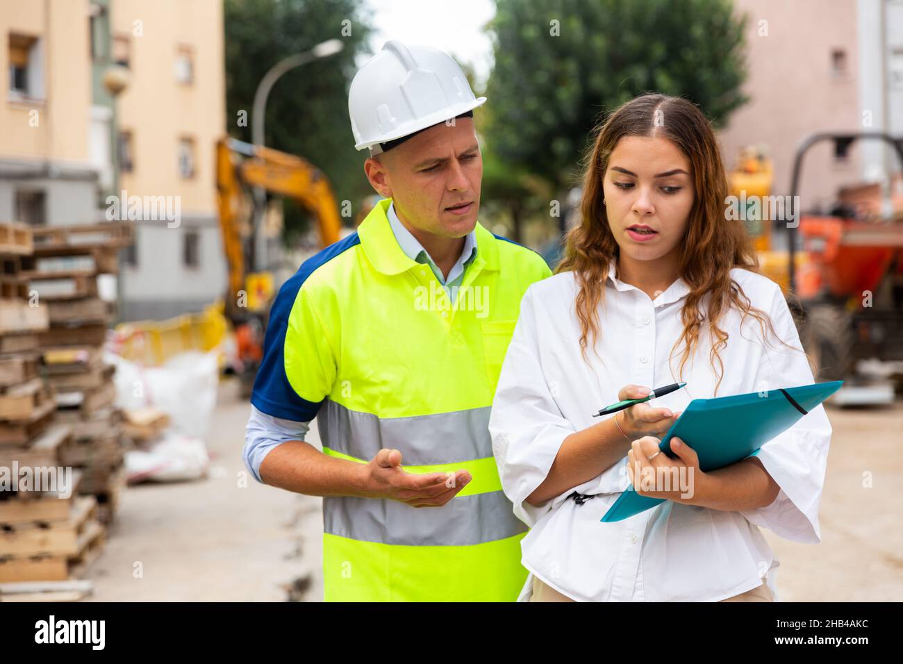 Master builder and architect talking in construction area Stock Photo ...
