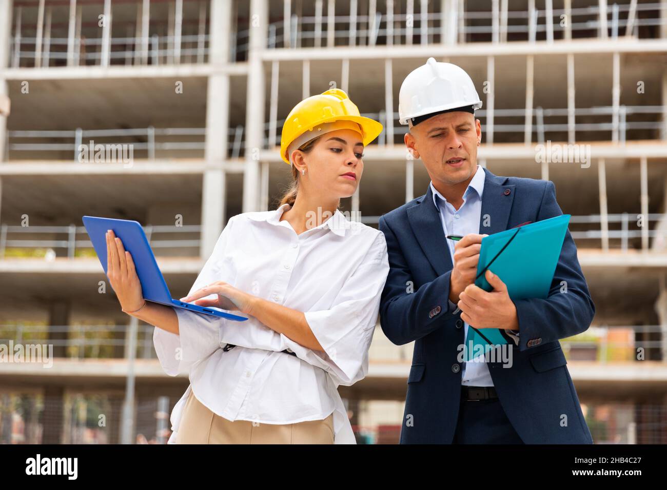 Man and woman engineers planning project of new building Stock Photo ...