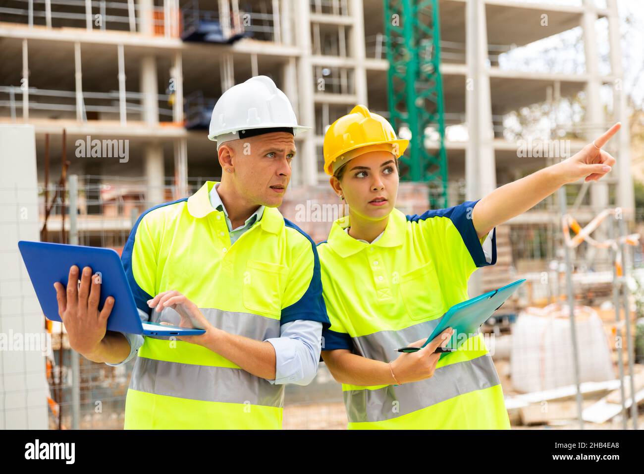 Man and woman engineers in construction site Stock Photo - Alamy