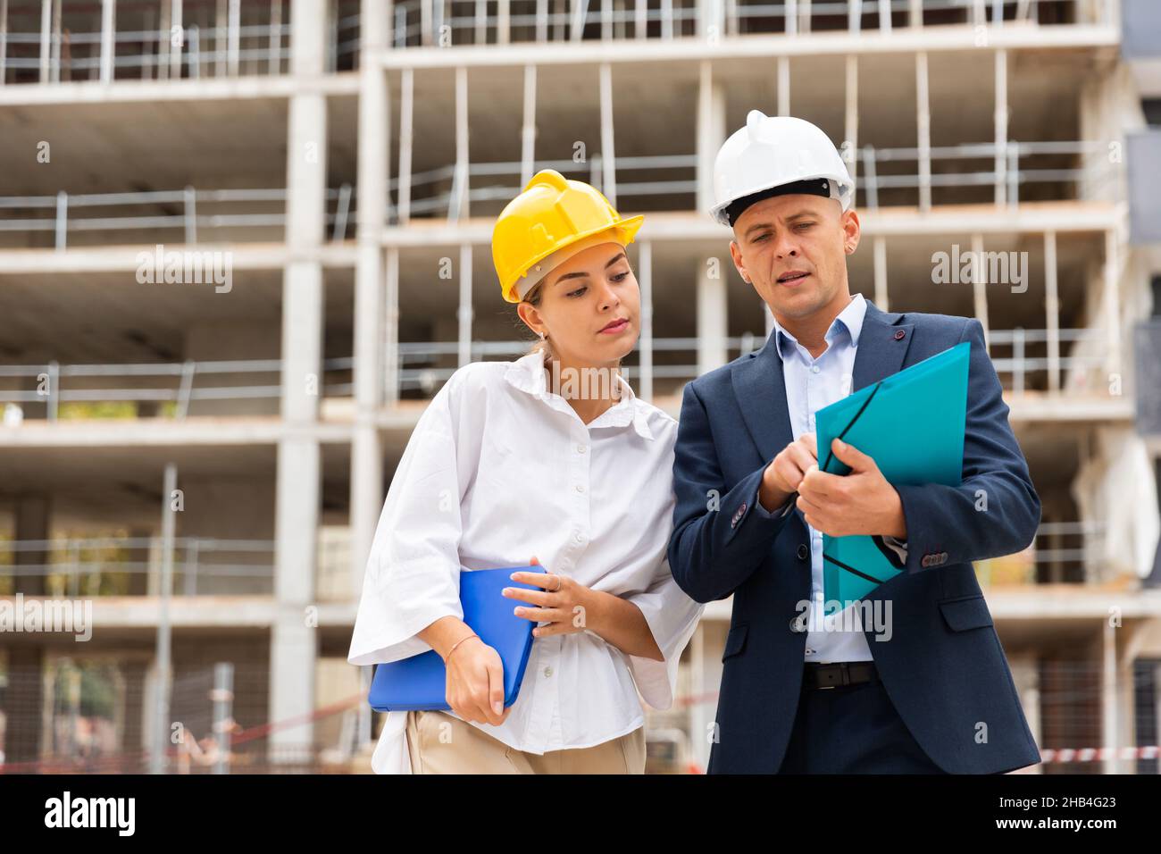 Man and woman engineers planning project of new building Stock Photo ...