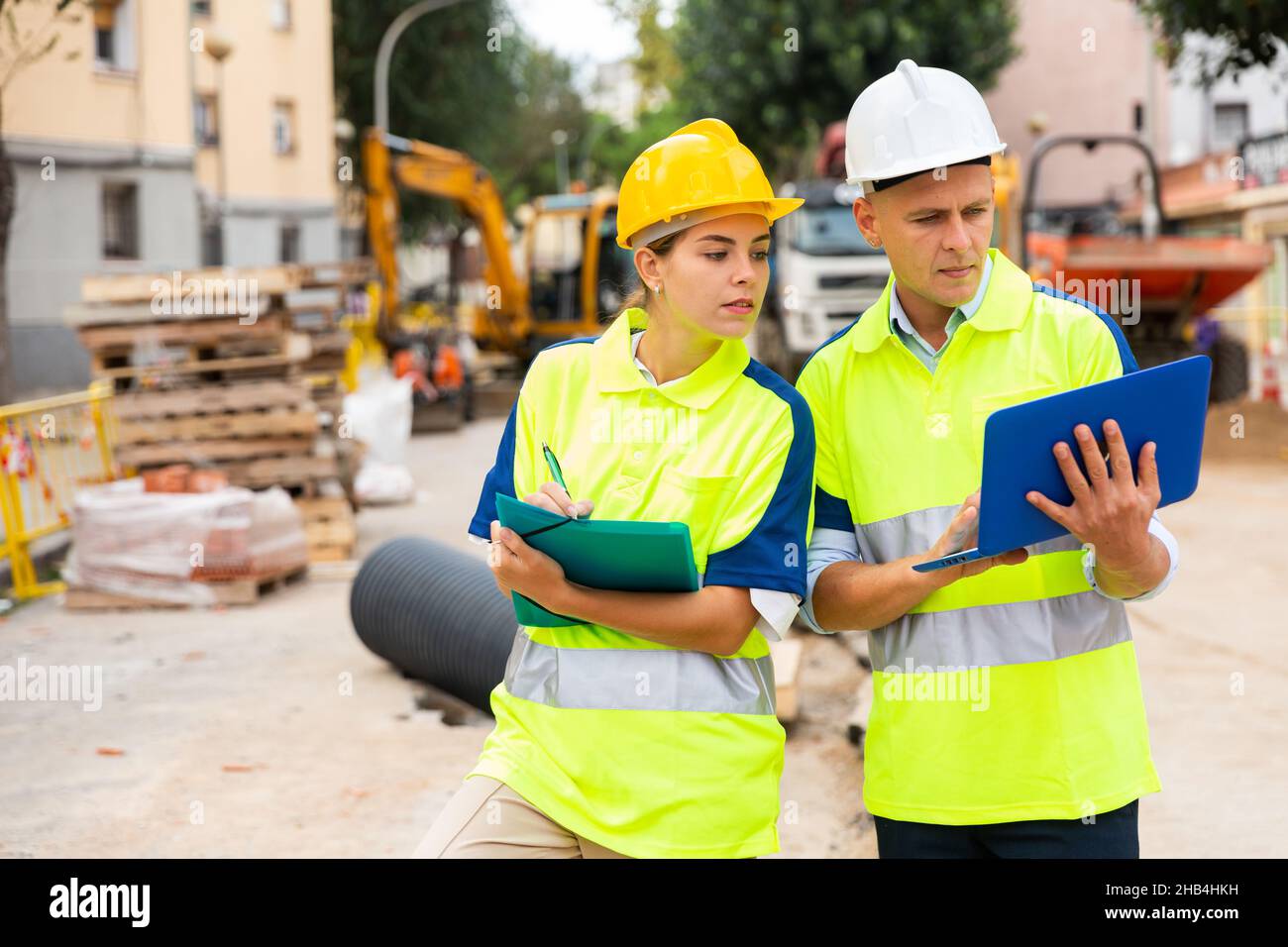 Male and female engineers in construction area Stock Photo - Alamy