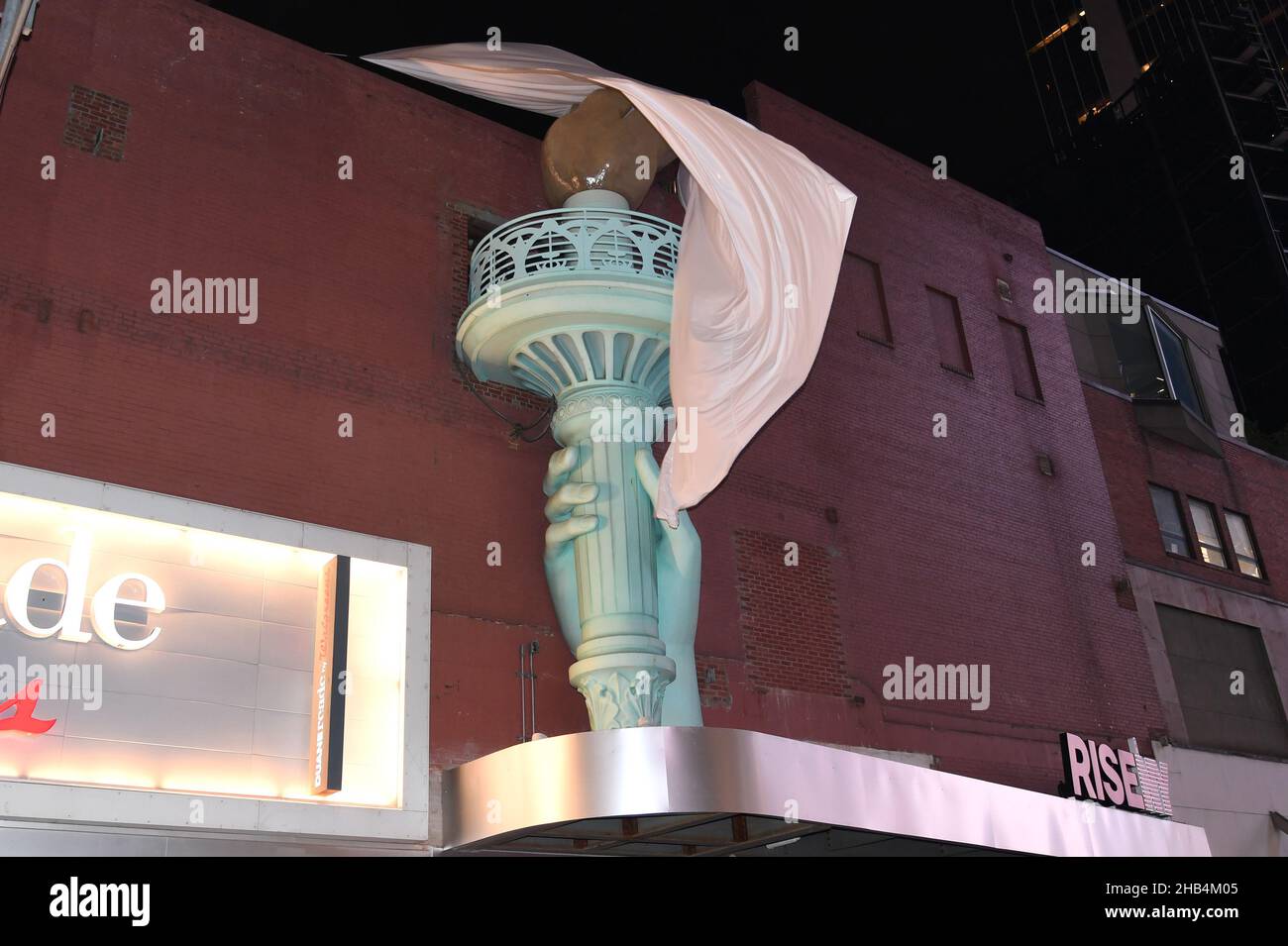 View of a replica of the Statue of Liberty torch at the RiseNY marquee ...