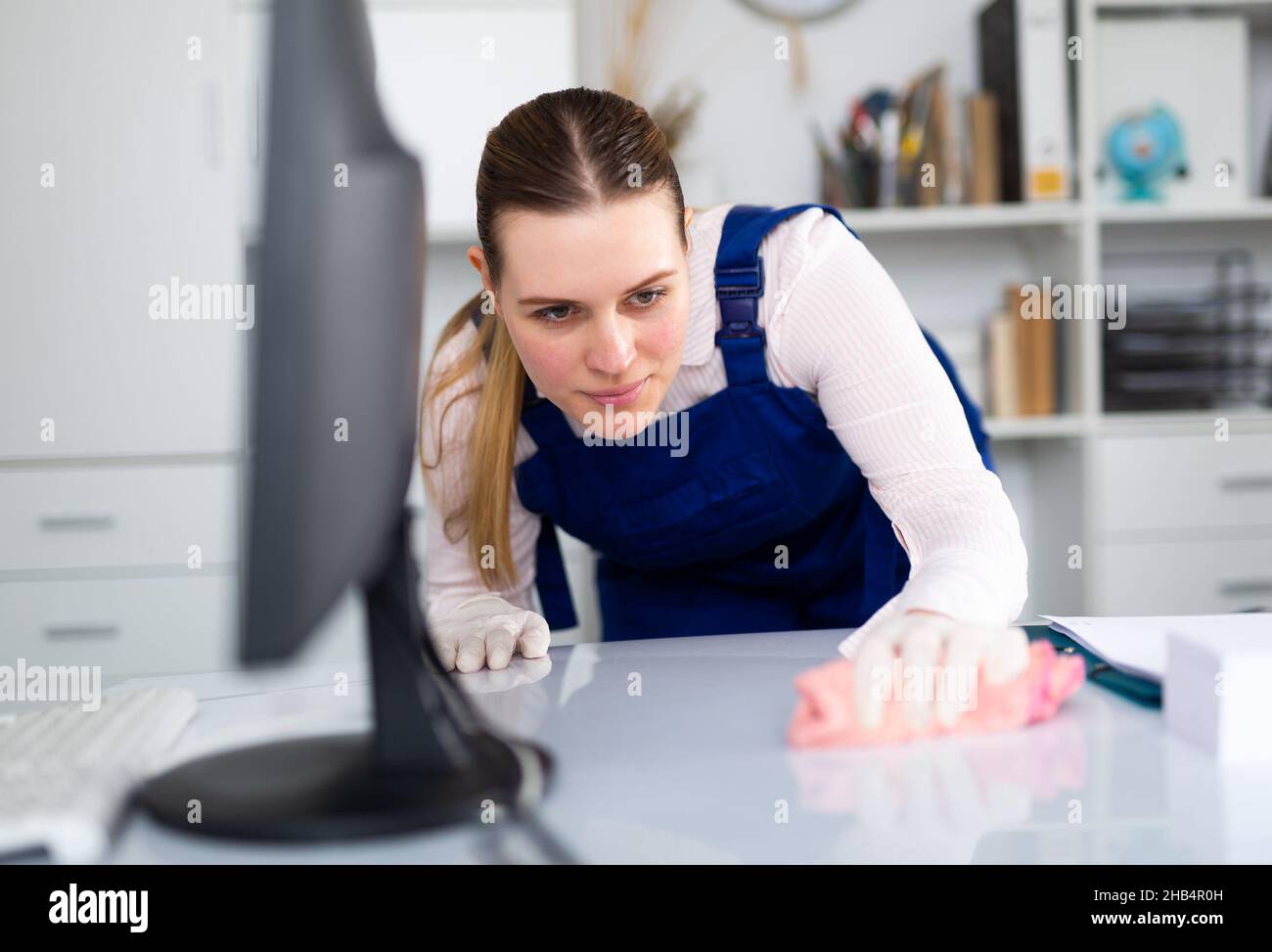Woman tidying desk hi-res stock photography and images - Alamy