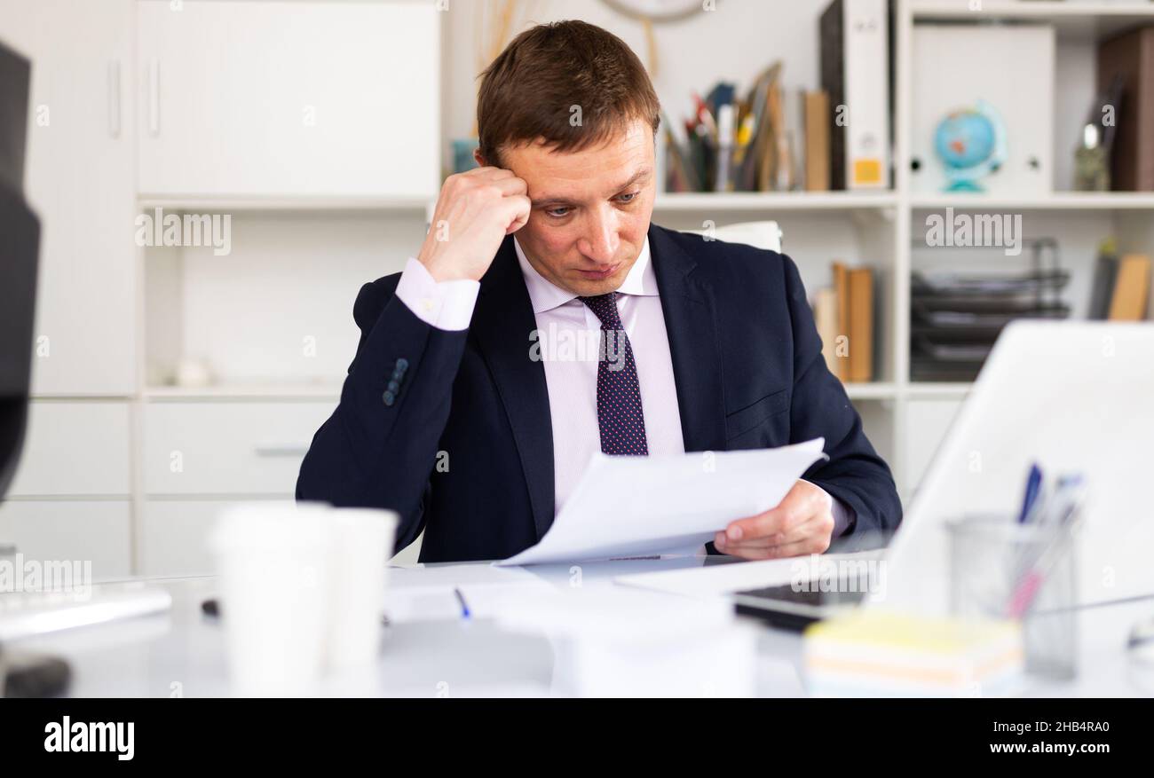 Serious entrepreneur working laptop papers hi-res stock photography and ...