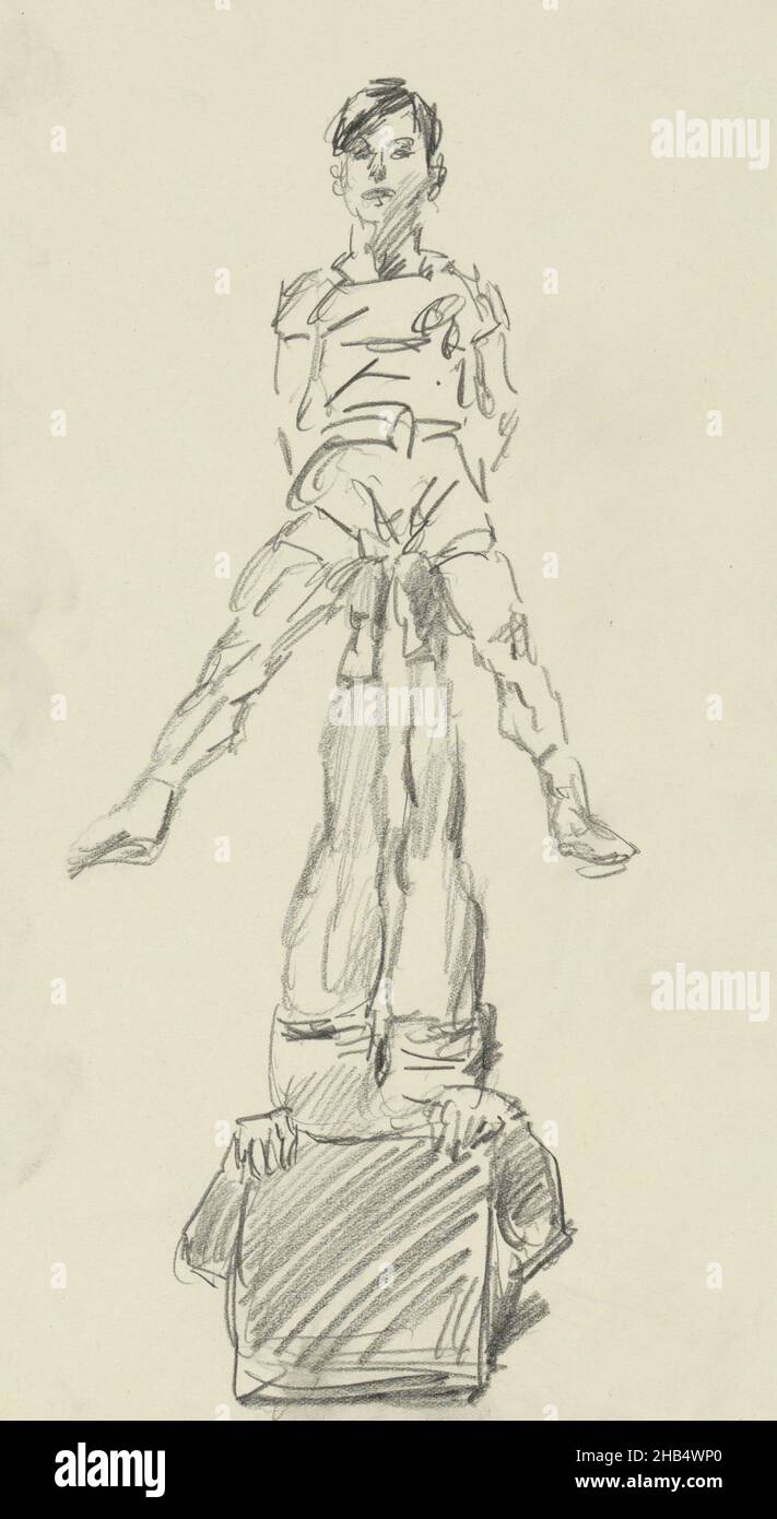 An acrobat sits with spread legs on the feet of an acrobat in candle ...