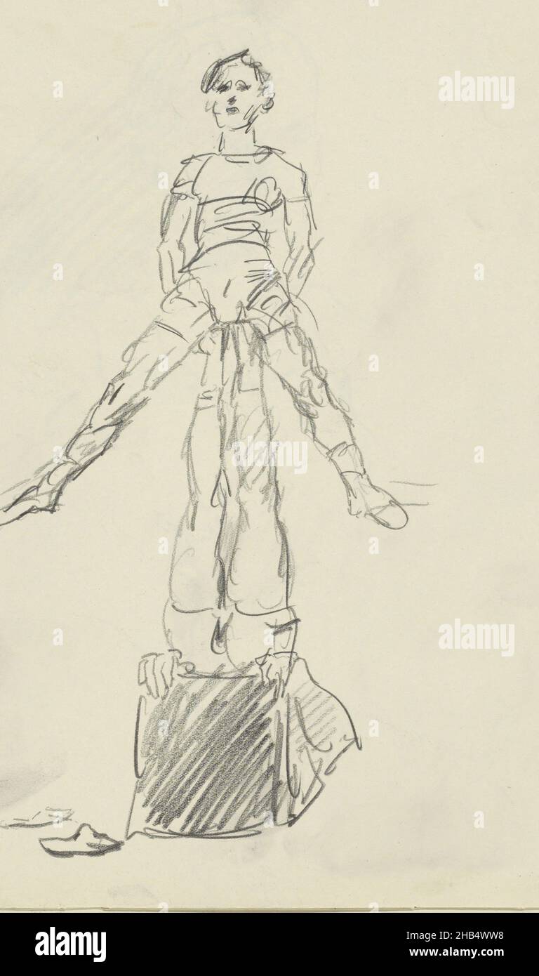 An acrobat sits with spread legs on the feet of an acrobat in candle ...