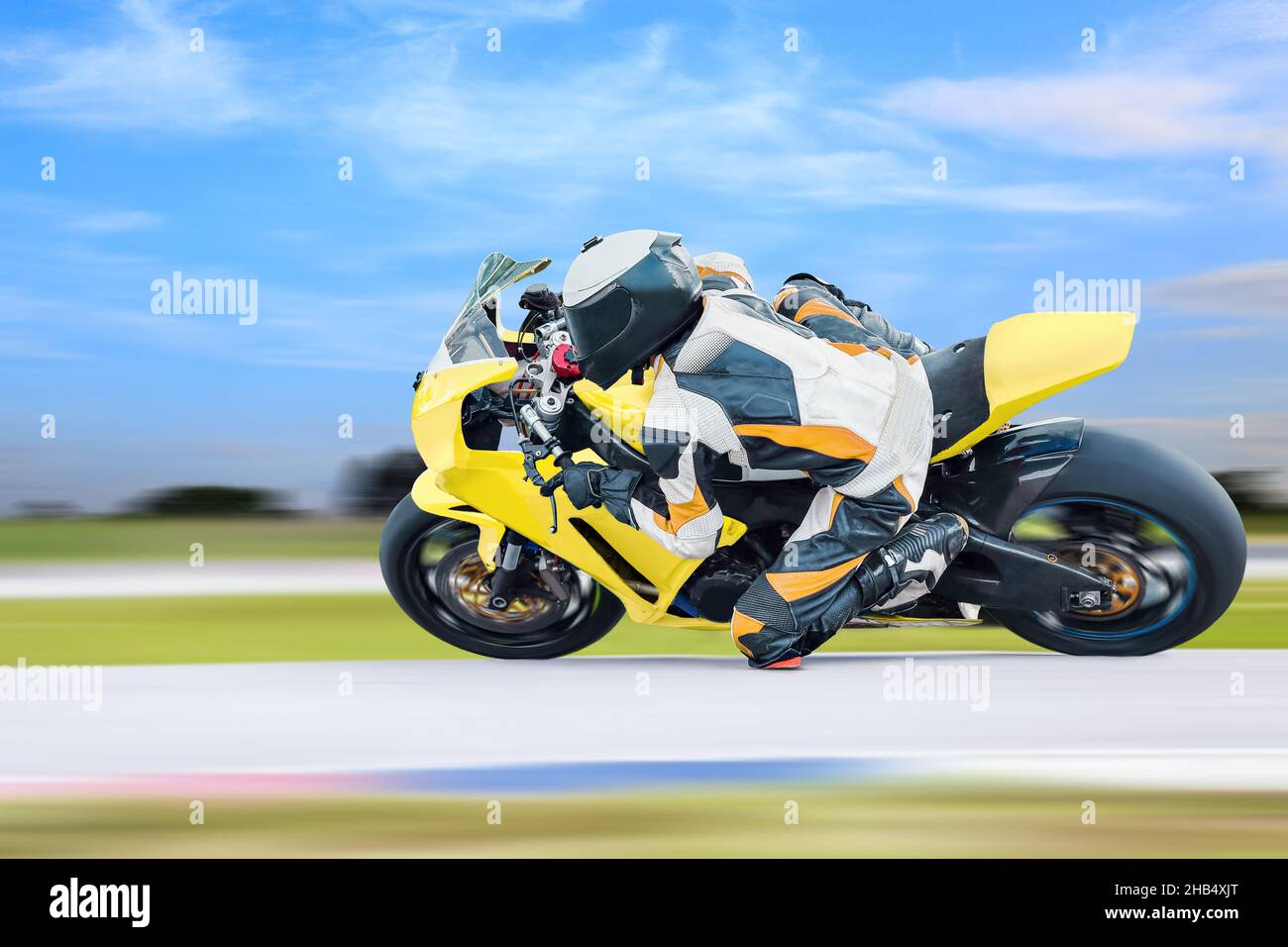 Motorcycle leaning into a fast corner on highway Stock Photo - Alamy