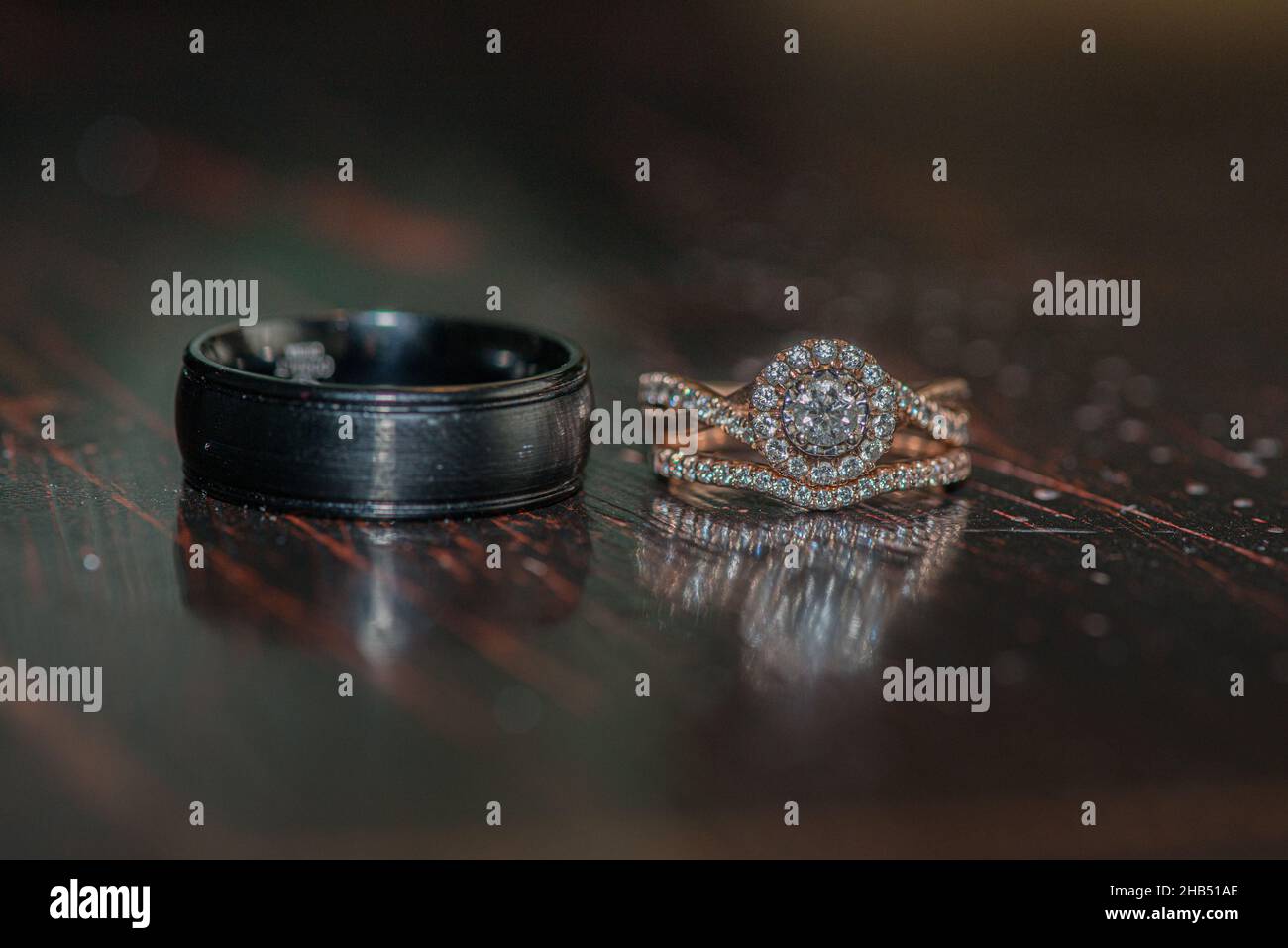 Bride and groom wedding rings on wood surface Stock Photo - Alamy