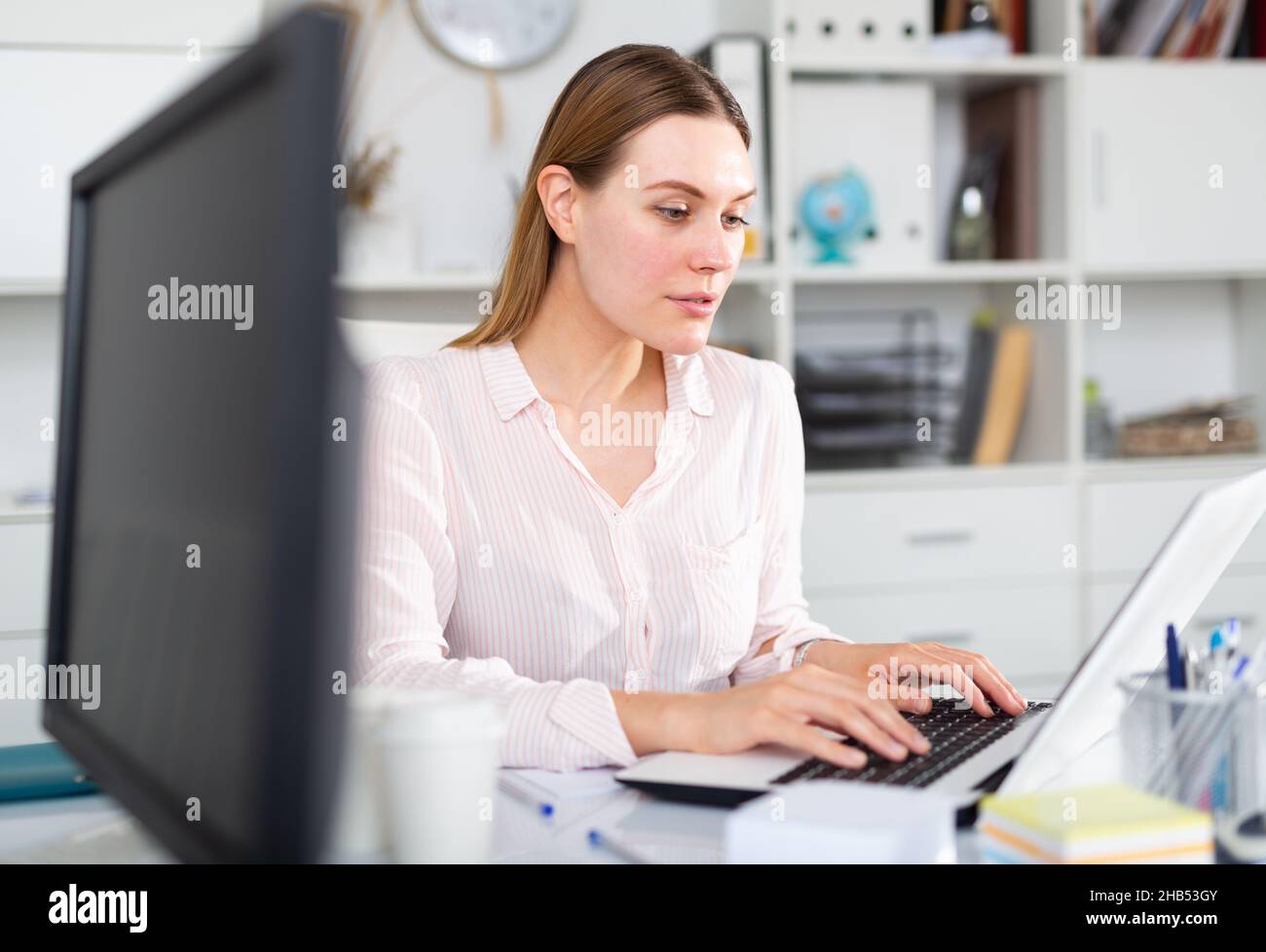 Young woman working at office alone Stock Photo - Alamy