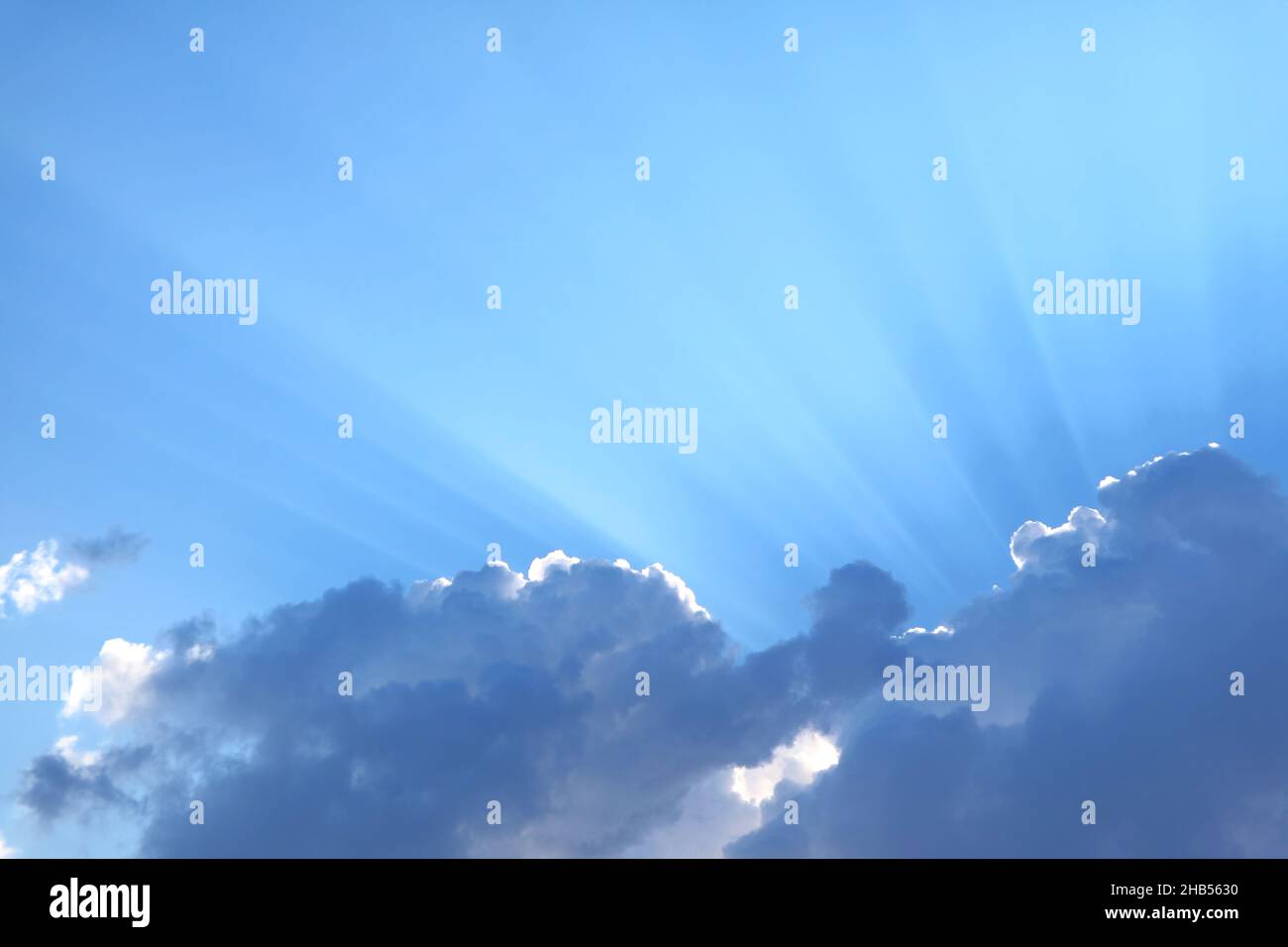 Spectacular Sun Rays Shining Through the Fluffy Clouds Stock Photo - Alamy