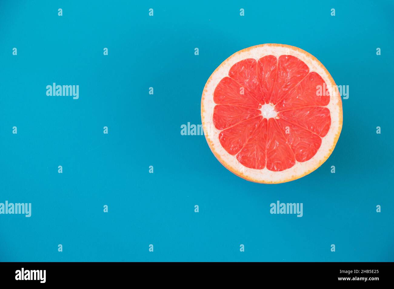 Sliced grapefruit on the blue background, cut grapefruit Stock Photo ...