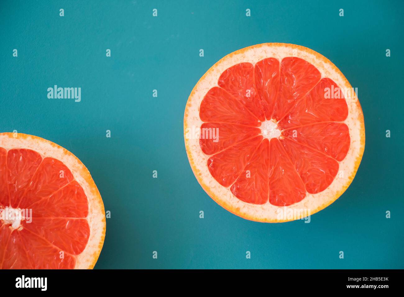 Sliced grapefruit on the blue background, cut grapefruit Stock Photo ...
